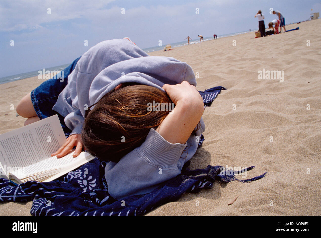 Reading on beach Stock Photo - Alamy