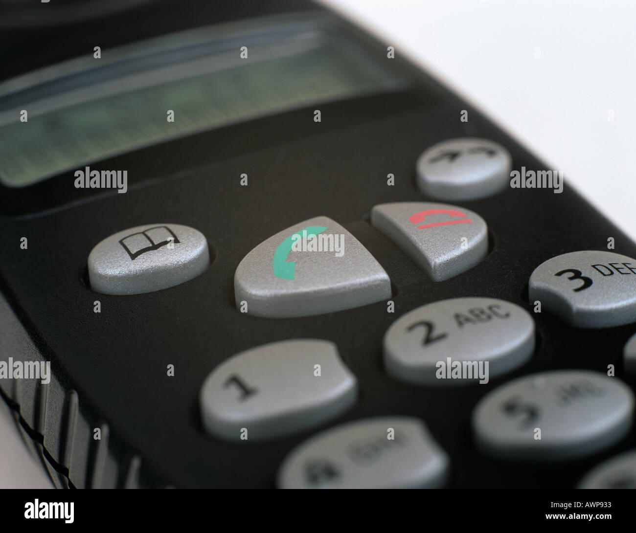 Keys of a black cordless telephone handset in close up focused on green ...