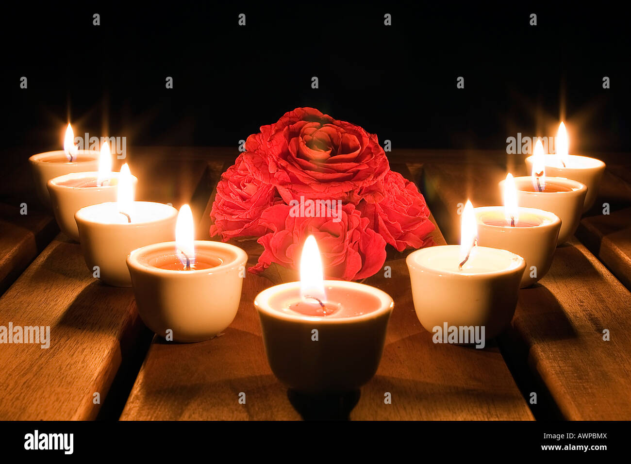 Roses in the light of tea candles Stock Photo - Alamy