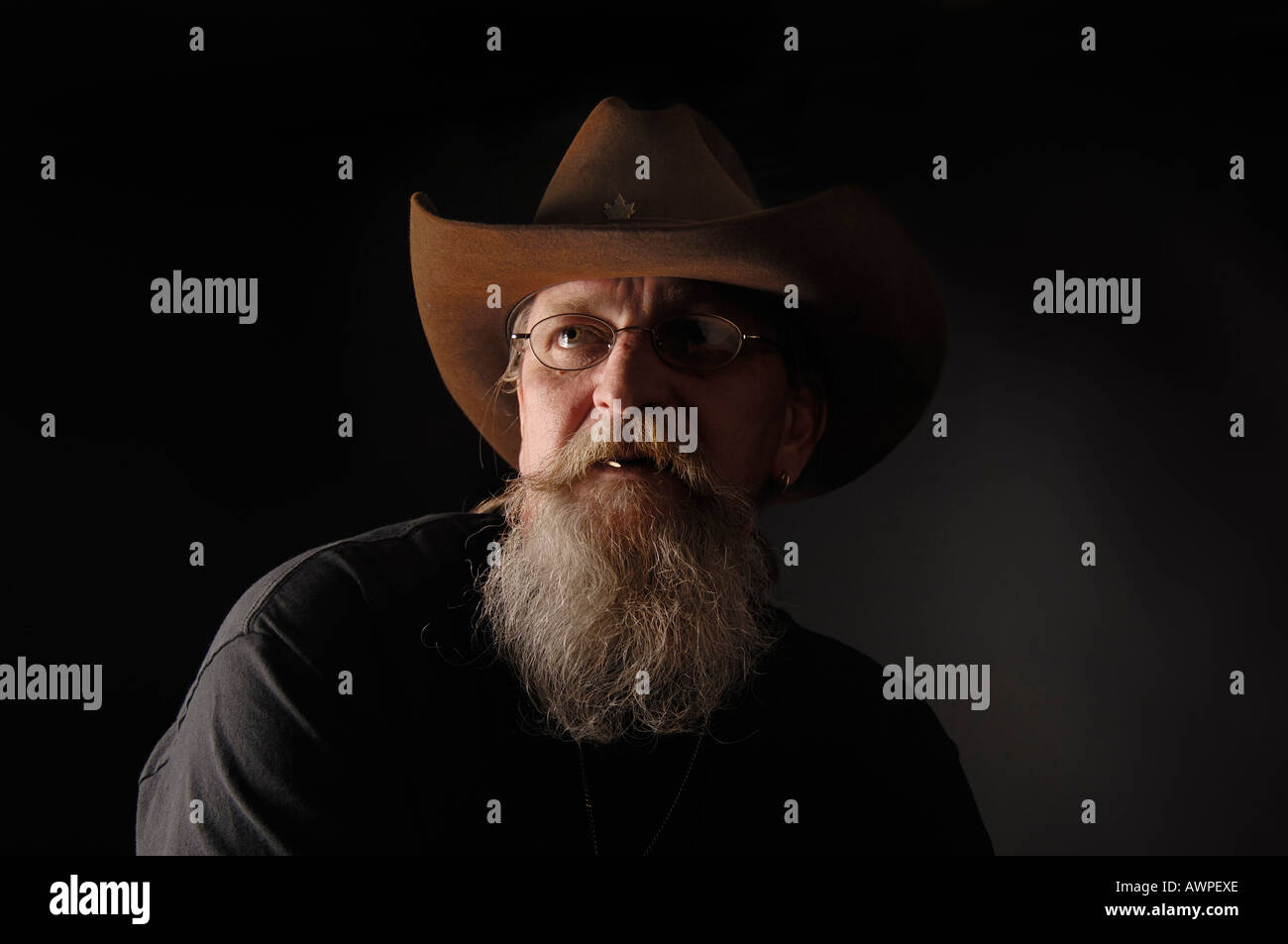 Portrait of a modern day cowboy. Low key. Dramatic lighting Stock Photo ...