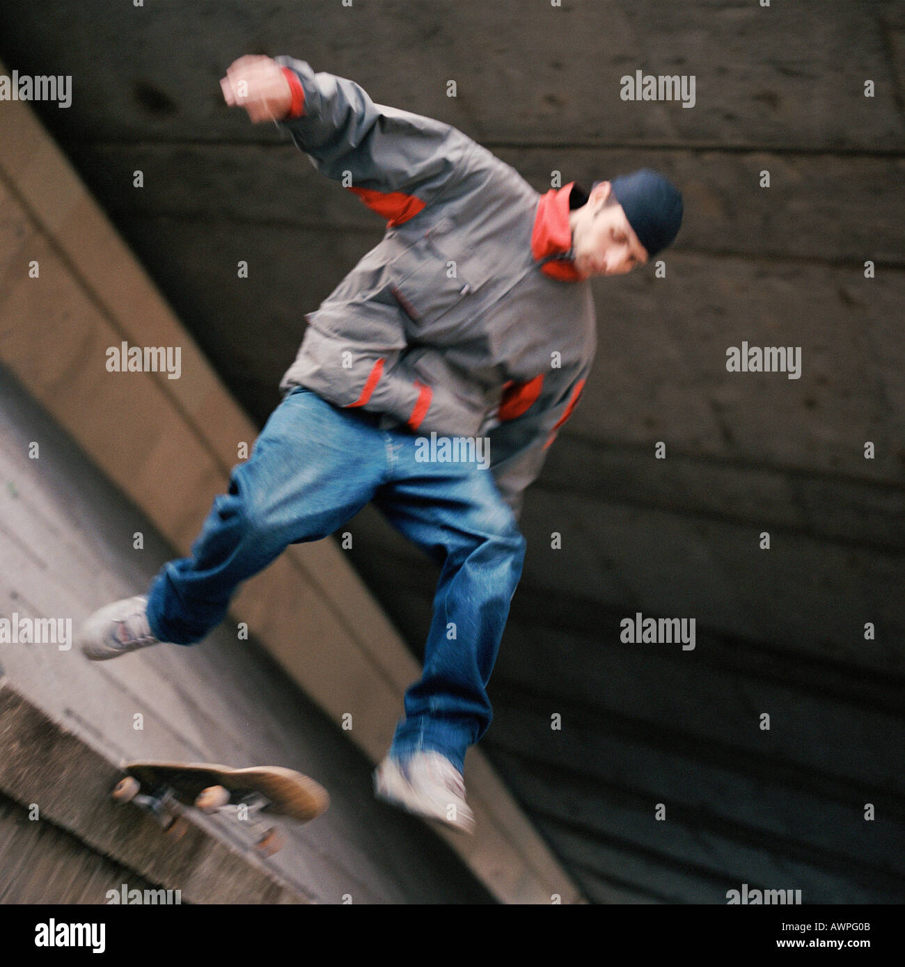 Young man in mid-air jump with skateboard Stock Photo - Alamy