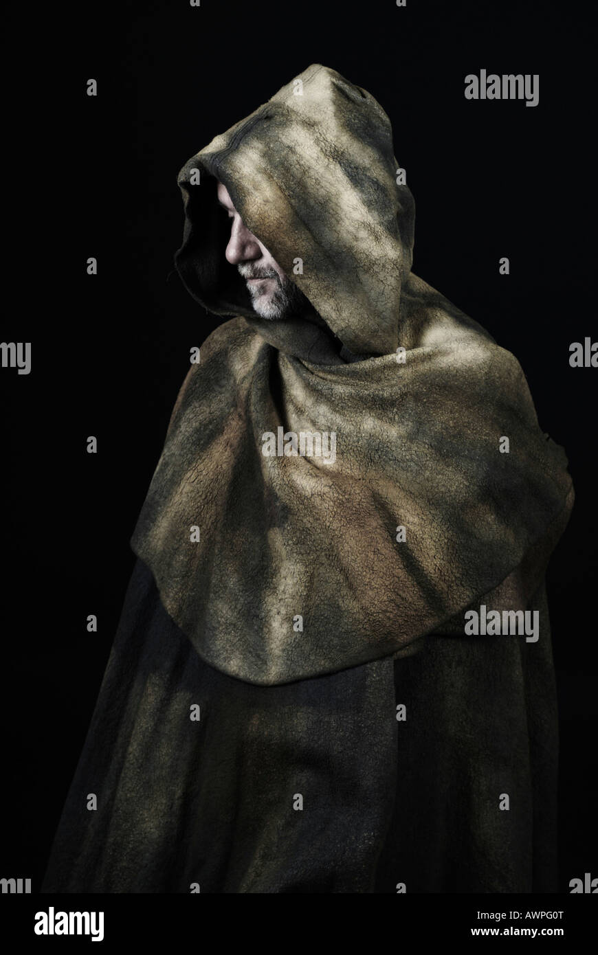 Hooded monk wearing cloak Stock Photo - Alamy