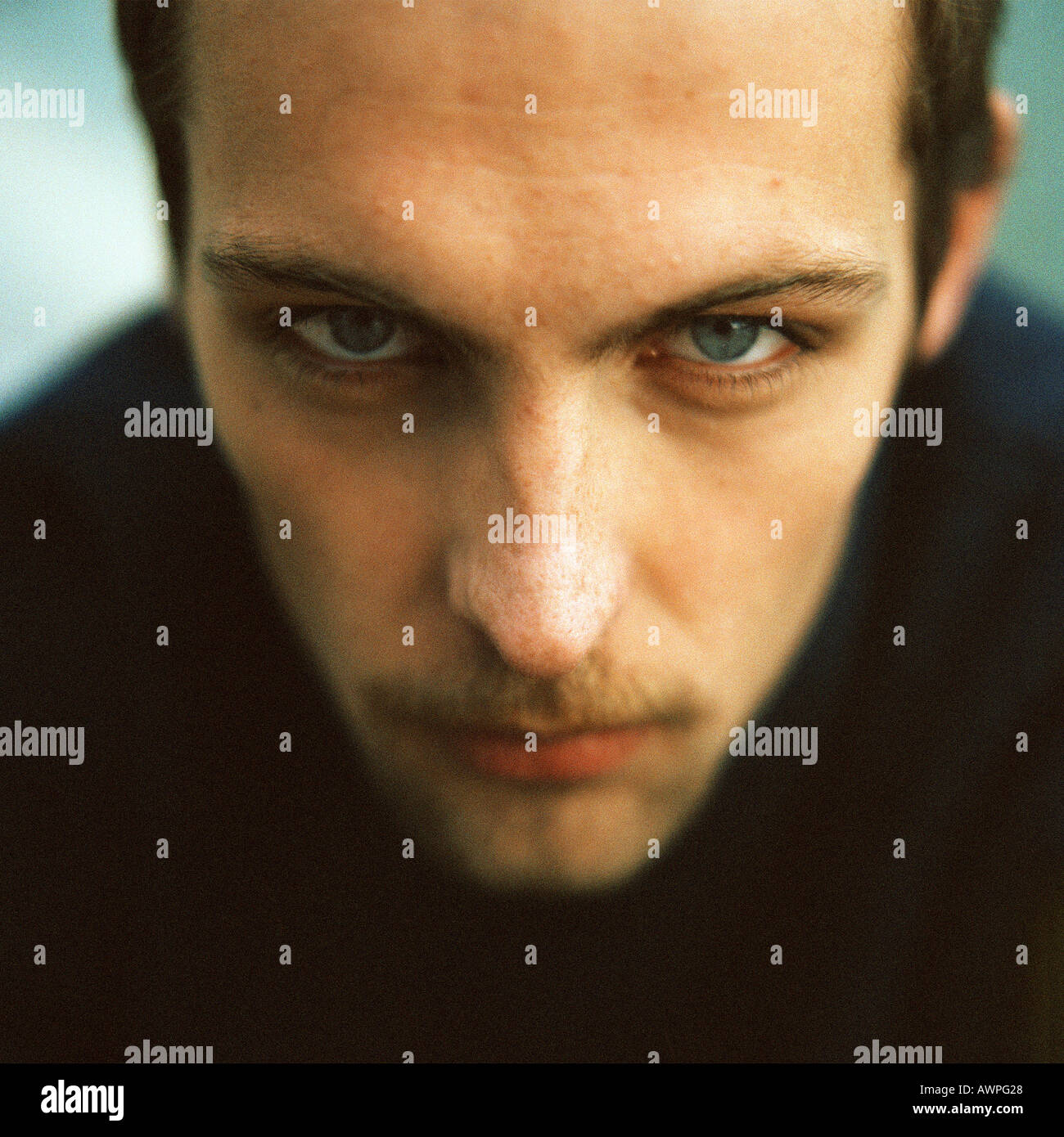 Young man looking into camera, close-up, portrait Stock Photo - Alamy