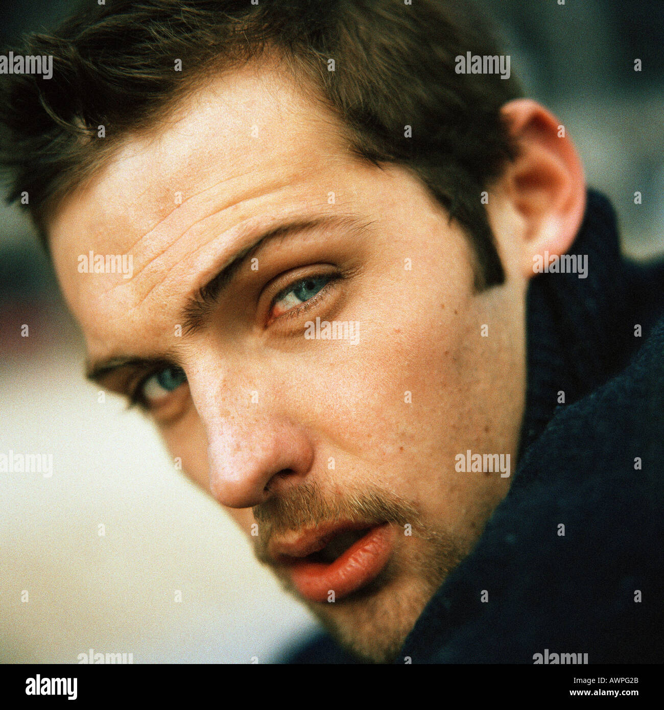 Yong man looking into camera, close-up, portrait Stock Photo - Alamy