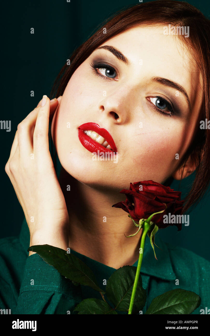 Young woman with red rose Stock Photo - Alamy