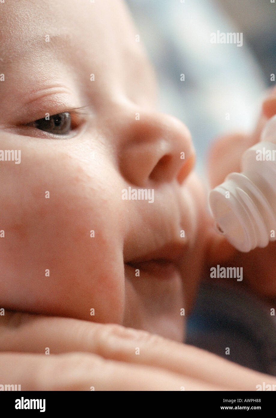 Baby's face and end of vitamin dropper, close-up Stock Photo - Alamy