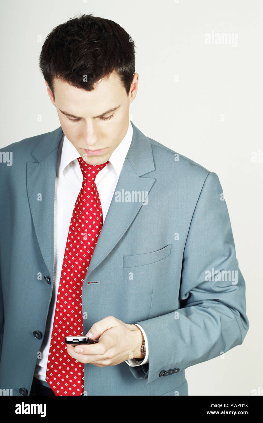 Young businessman dialing a number on his mobile phone Stock Photo - Alamy