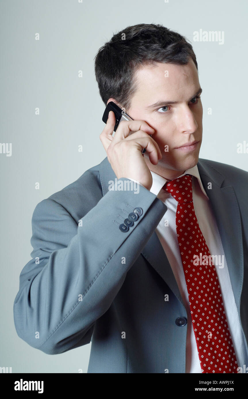 Young businessman making a call with his mobile phone Stock Photo - Alamy