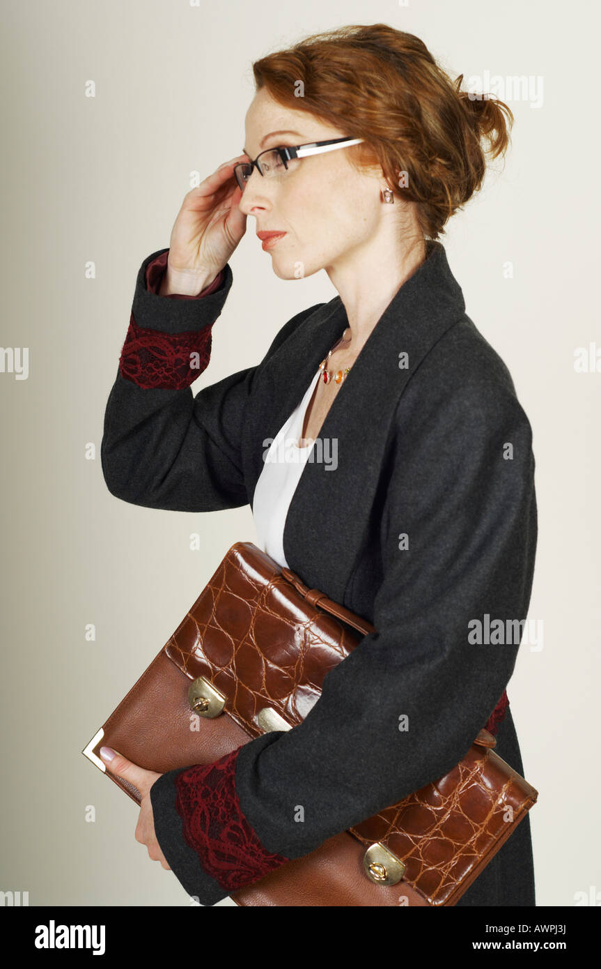 Businesswoman wearing eyeglasses holding briefcase Stock Photo - Alamy