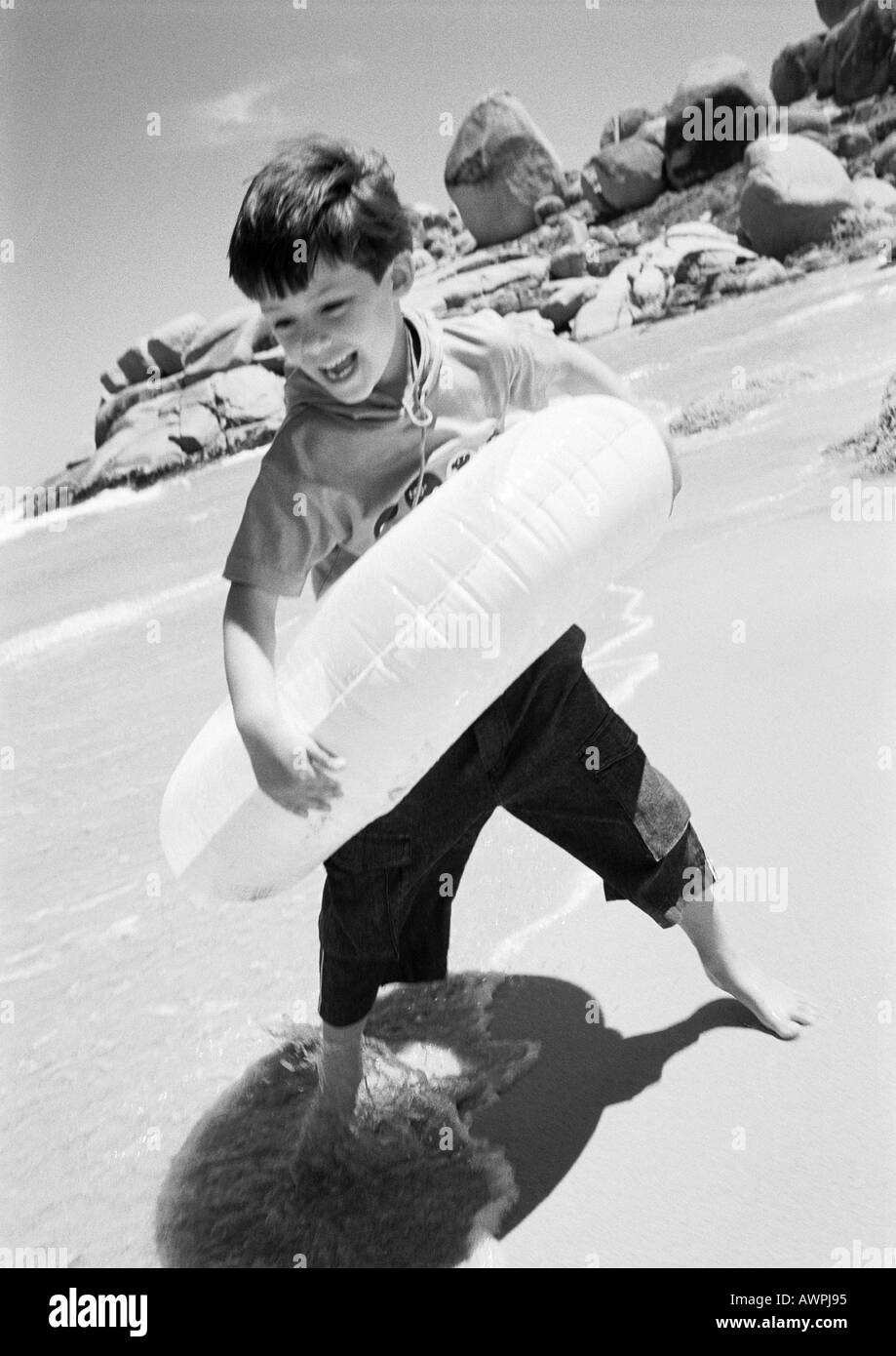 Child in inner tube at the beach, B&W Stock Photo - Alamy