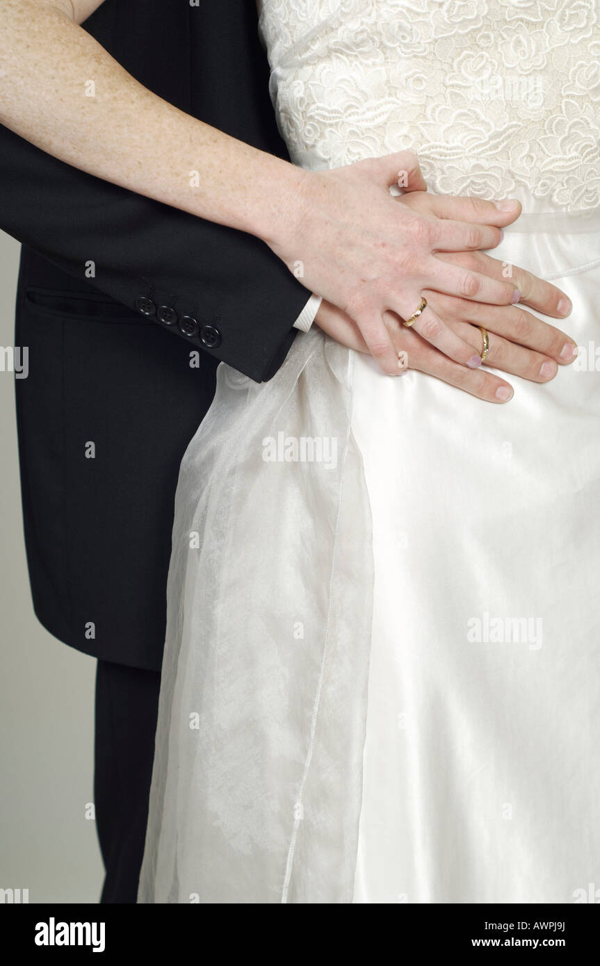 Bride and groom holding hands Stock Photo - Alamy