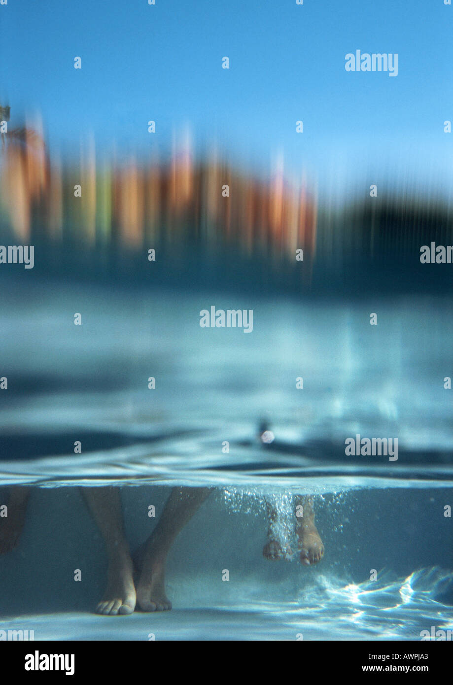 Two pairs of feet in water, underwater view Stock Photo - Alamy