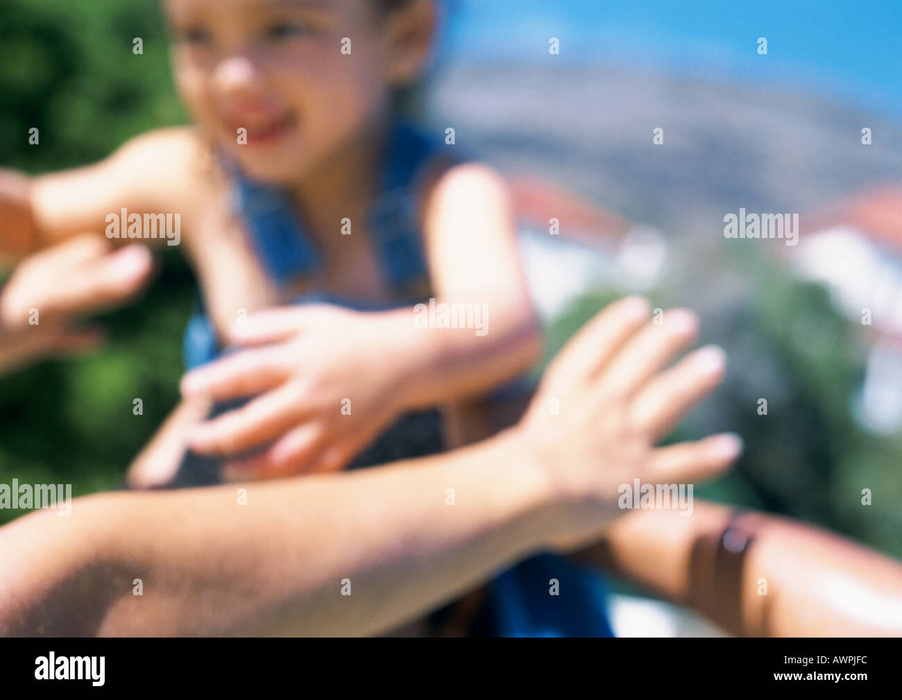 Child reaching arms toward adult, blurred Stock Photo - Alamy