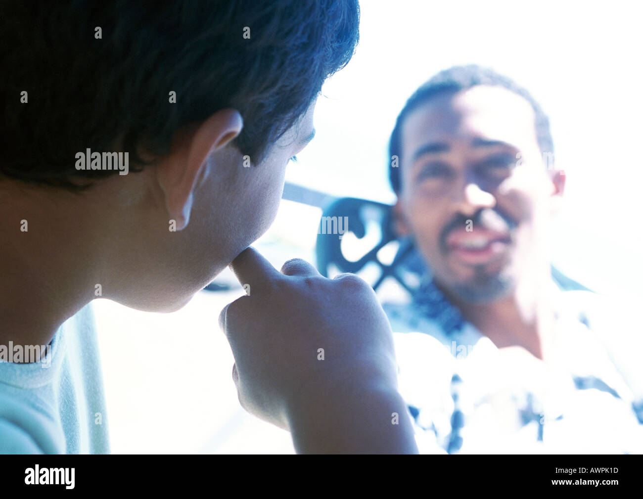Man and boy talking, close-up Stock Photo - Alamy