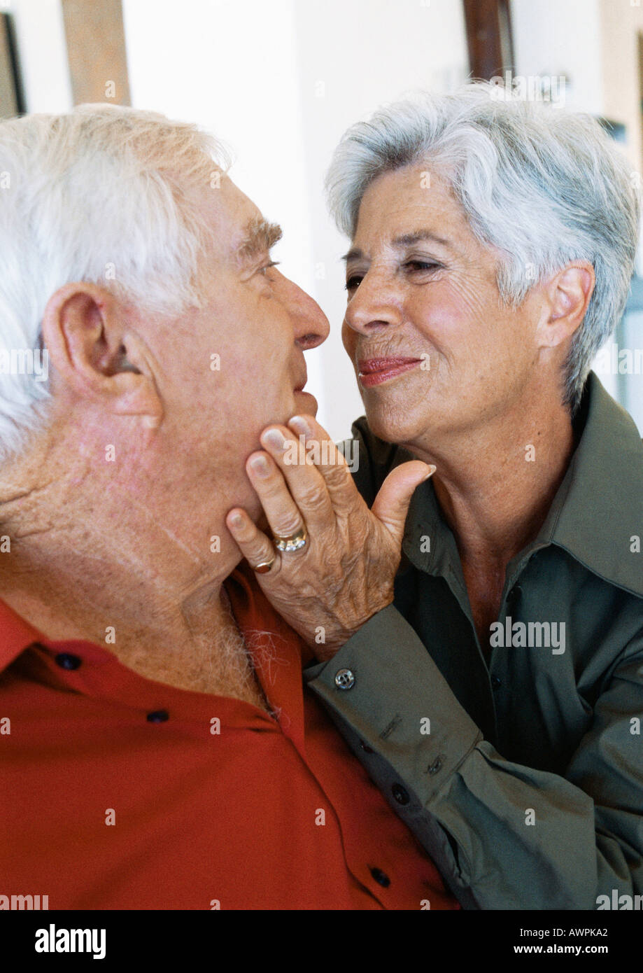 Senior couple, woman caressing man's face Stock Photo - Alamy