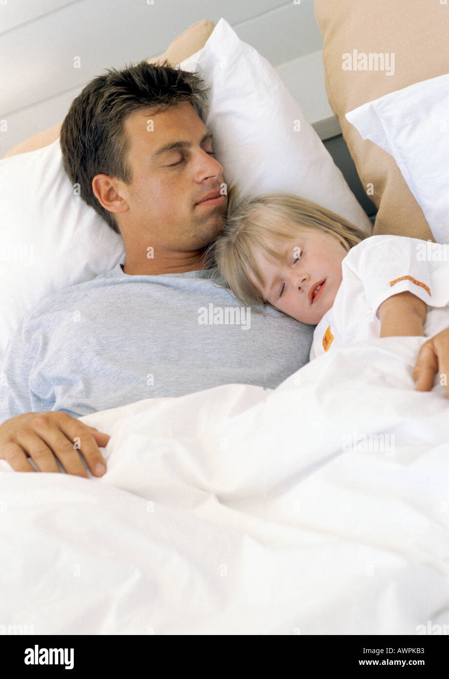 Father and daughter sleeping in bed Stock Photo - Alamy