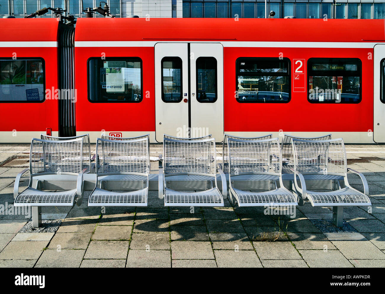 Passenger's chairs on a platform in front of urban train wagons Stock ...