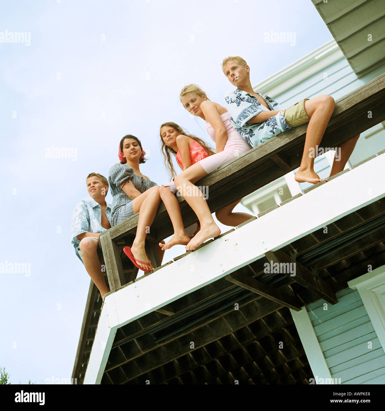 Young people sitting on balcony, low angle view Stock Photo - Alamy