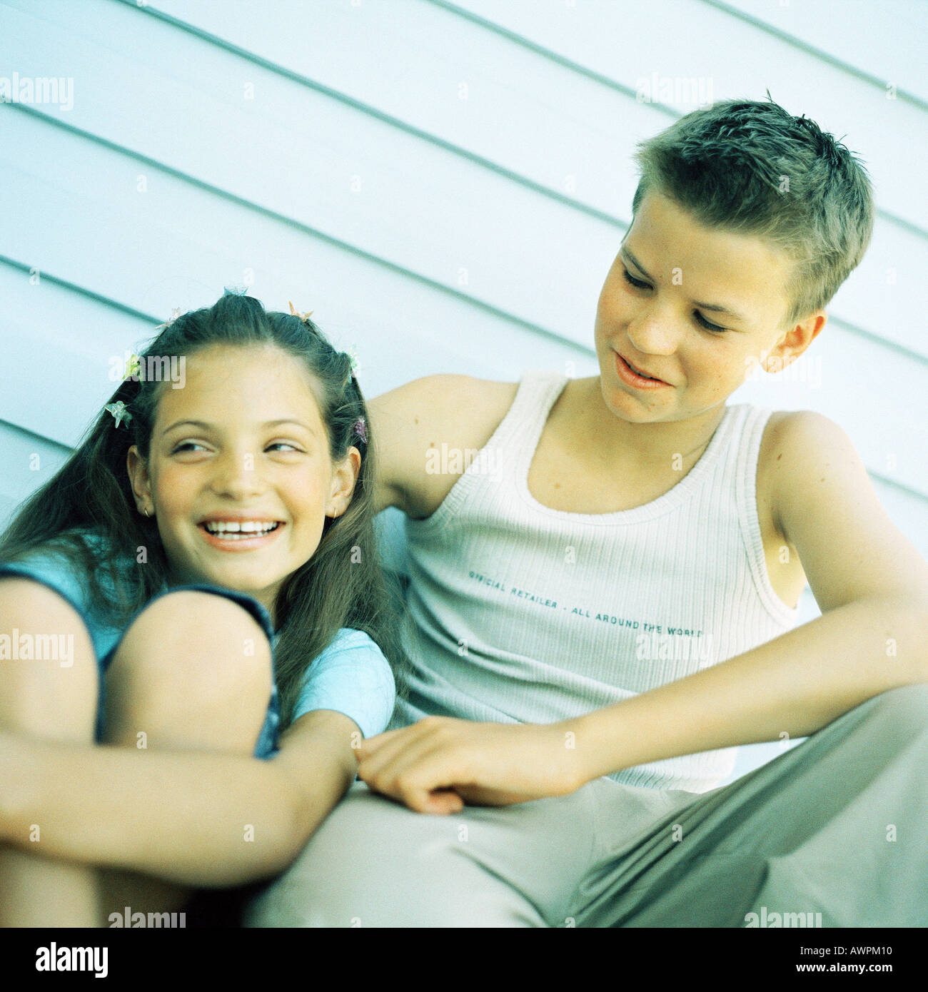 Two children sitting side by side, outside Stock Photo - Alamy