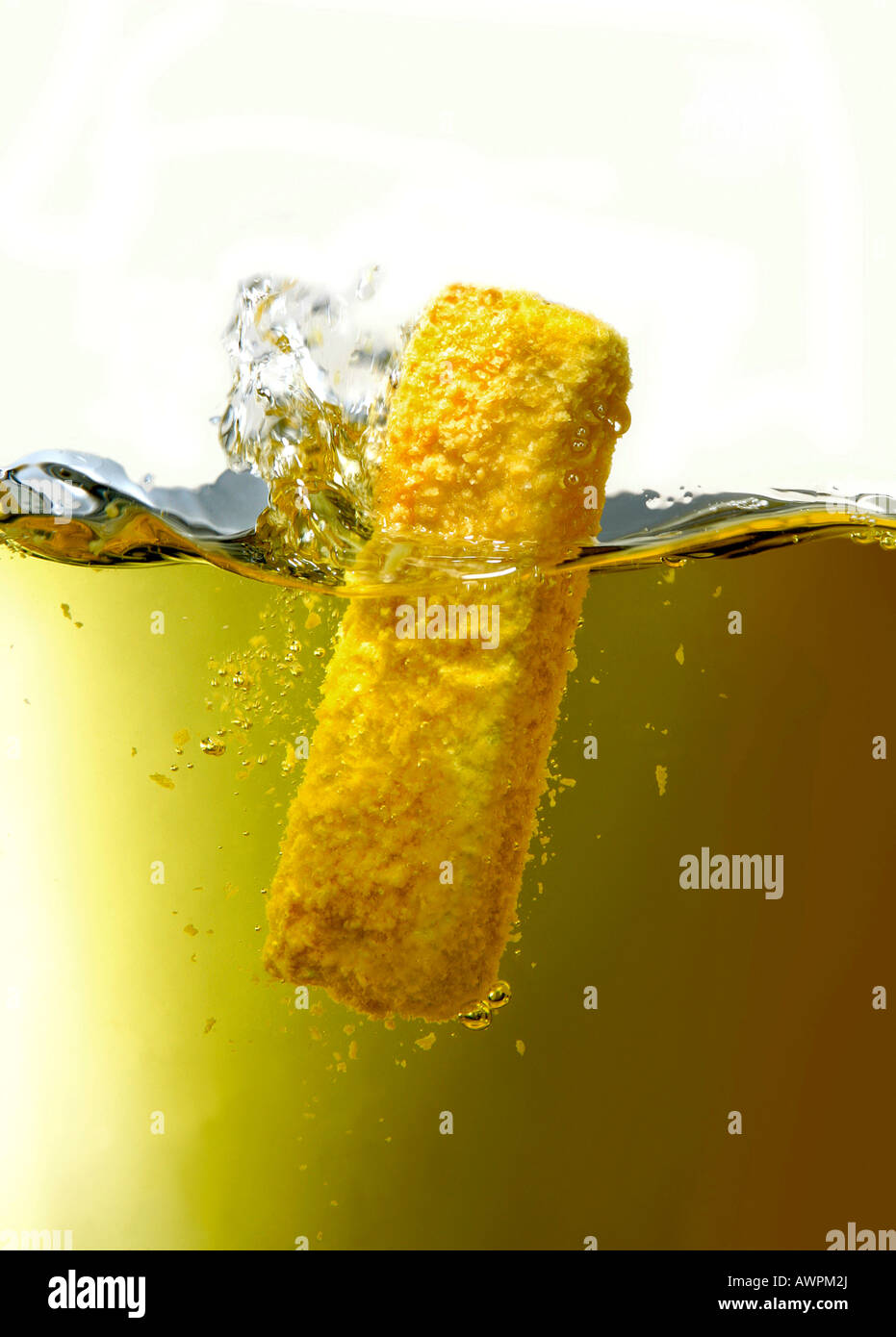 Fishstick (fishfinger) falling into cooking oil Stock Photo - Alamy