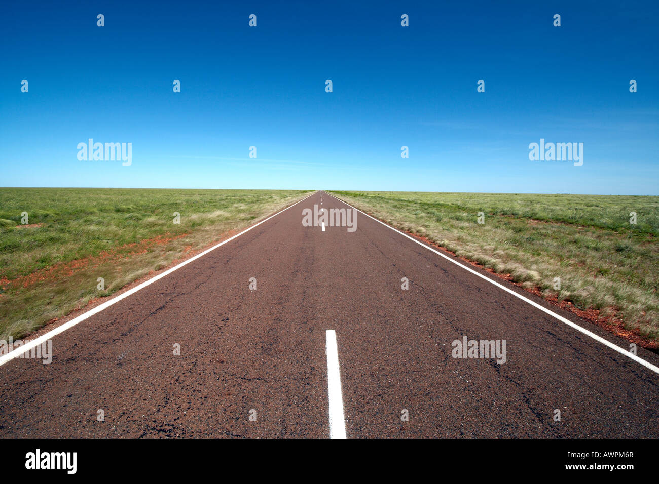 Straight Desert Road under a bright blue sky in Northern Territory ...