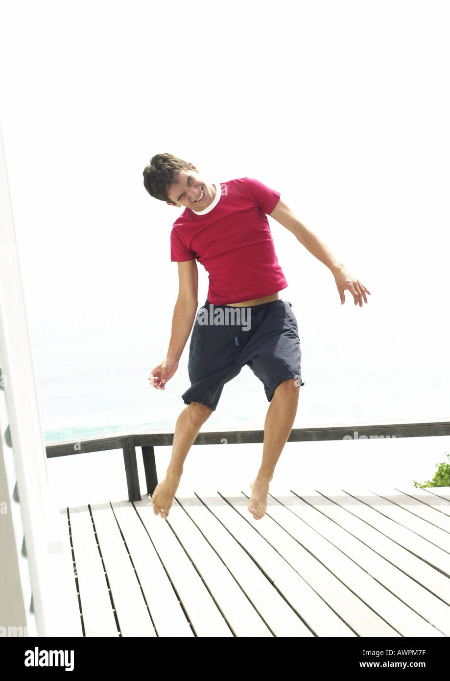 Teenage boy jumping Stock Photo - Alamy