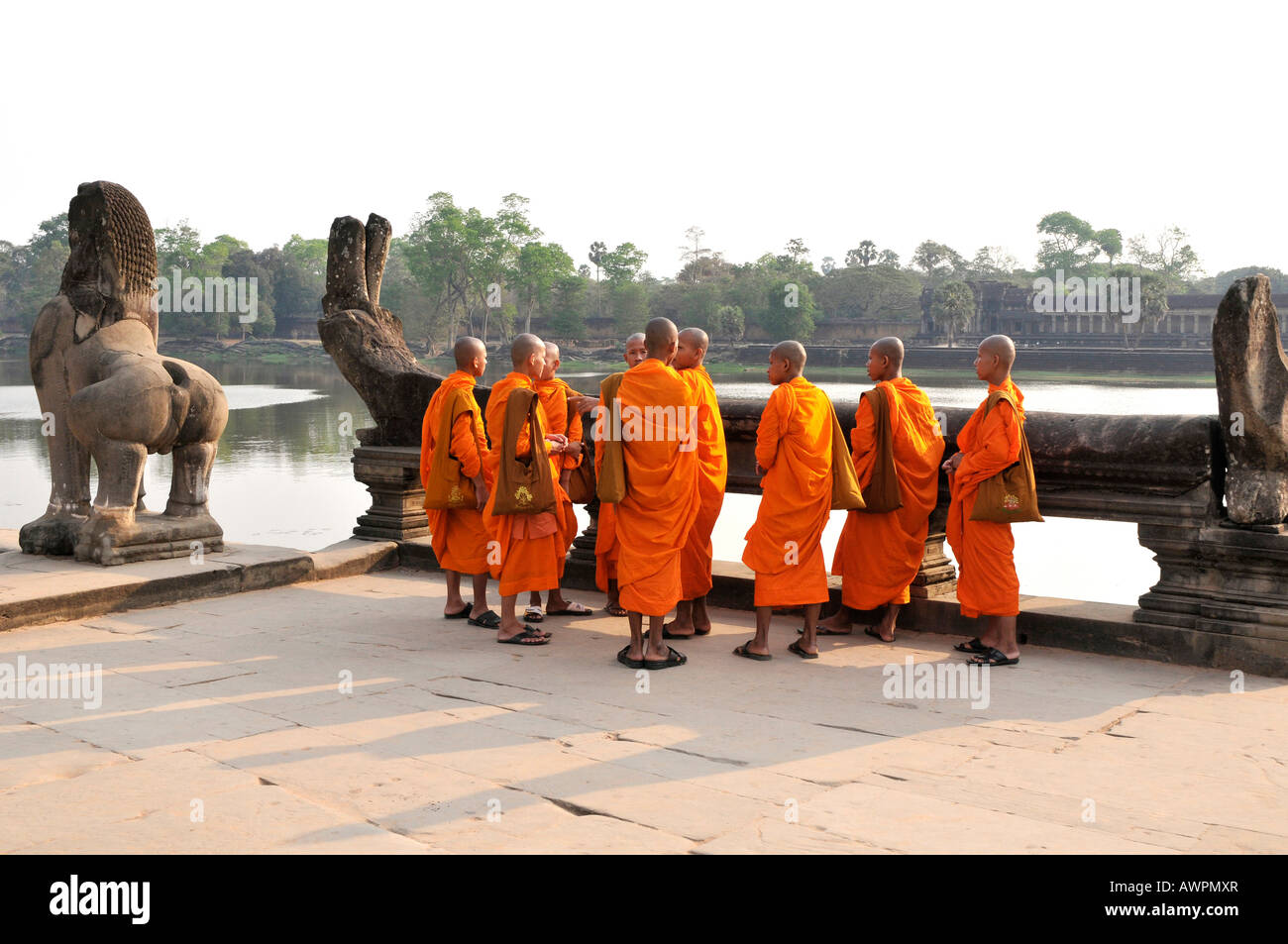 Buddhist monks, castle moat, Angkor Wat Temple, Cambodia, Southeast ...