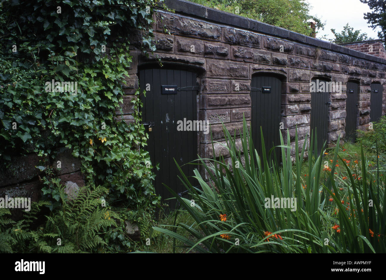Stone-faced entrance to tunnels built into earth bank (for storage ...