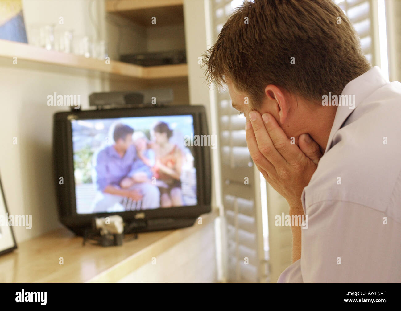 Young man watches television in hi-res stock photography and images - Alamy