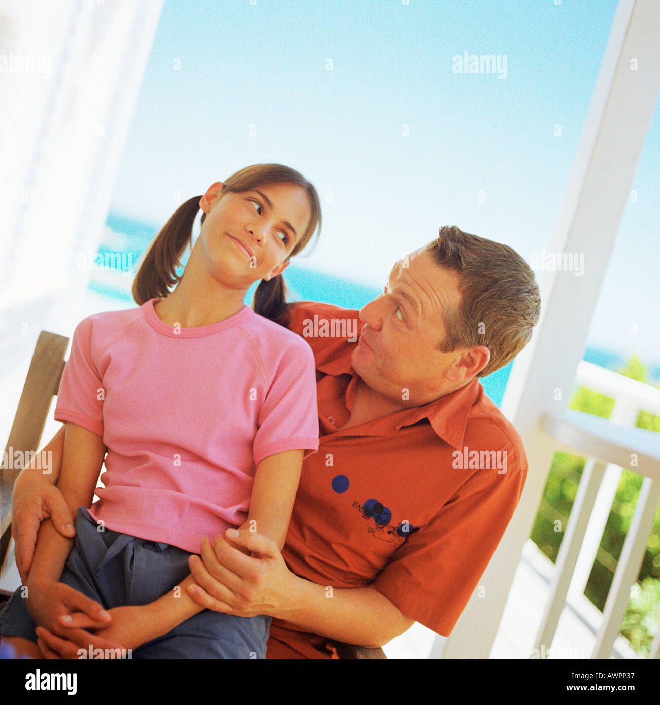 Daughter sitting on fathers lap hi-res stock photography and images - Alamy