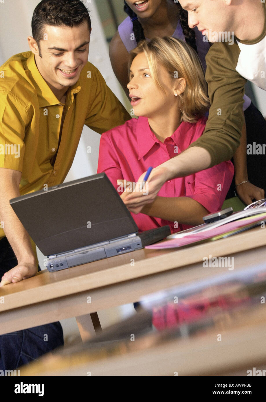 Business people grouped around laptop hi-res stock photography and ...