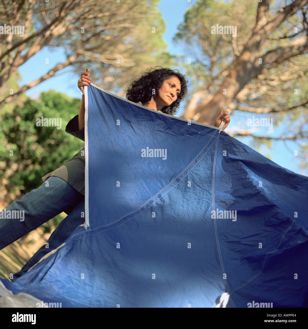 Woman setting up tent Stock Photo - Alamy
