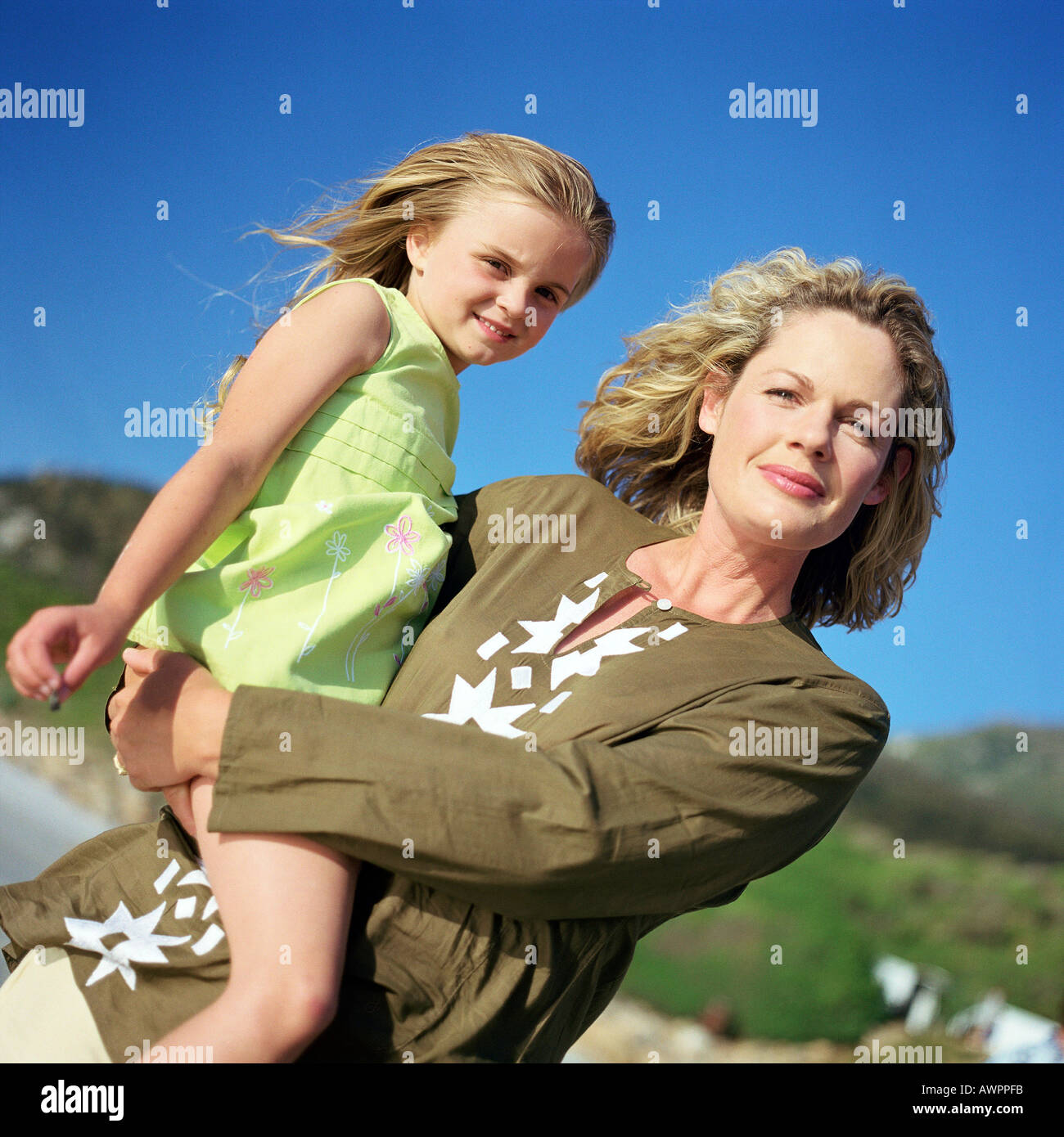 Woman carrying little girl, portrait Stock Photo - Alamy