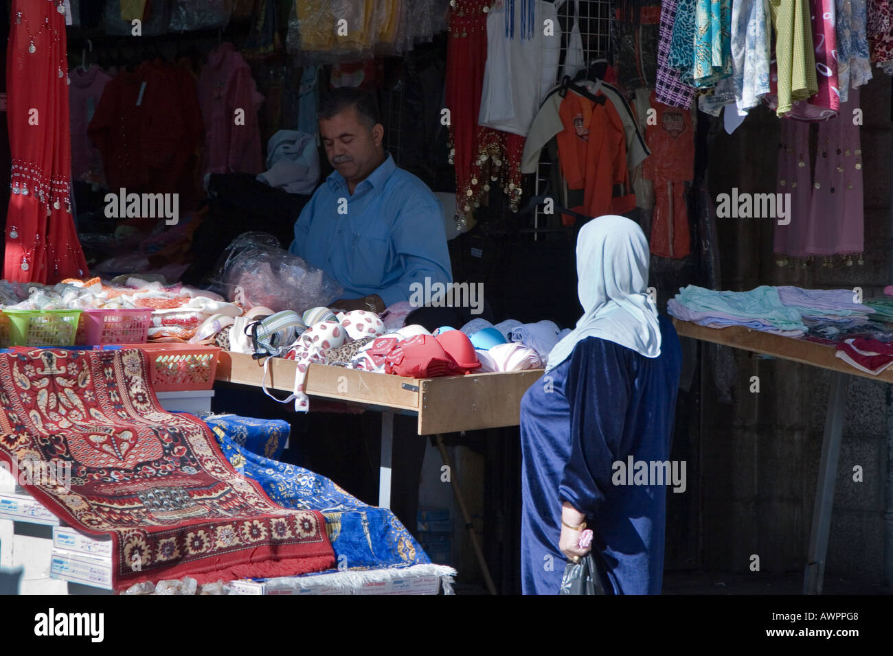 Stock Photo of a Male Merchant and a Female Shopper in a Small Clothes ...