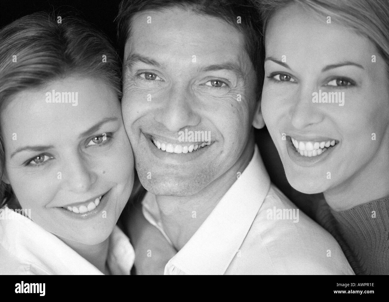 Two women and man side by side, smiling, close-up, portrait, b&w Stock ...