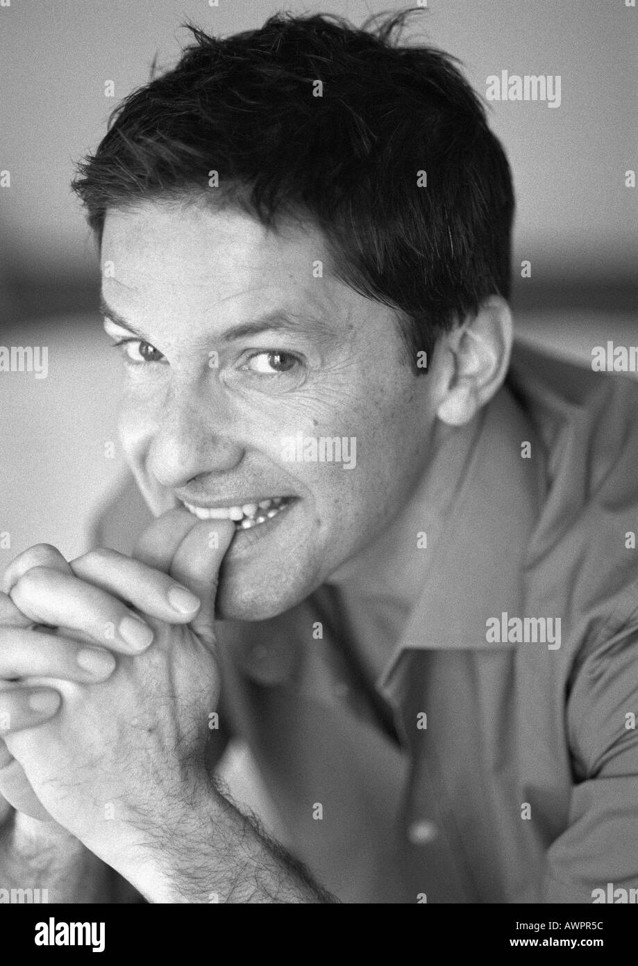 Man biting thumbs, portrait, b&w Stock Photo - Alamy