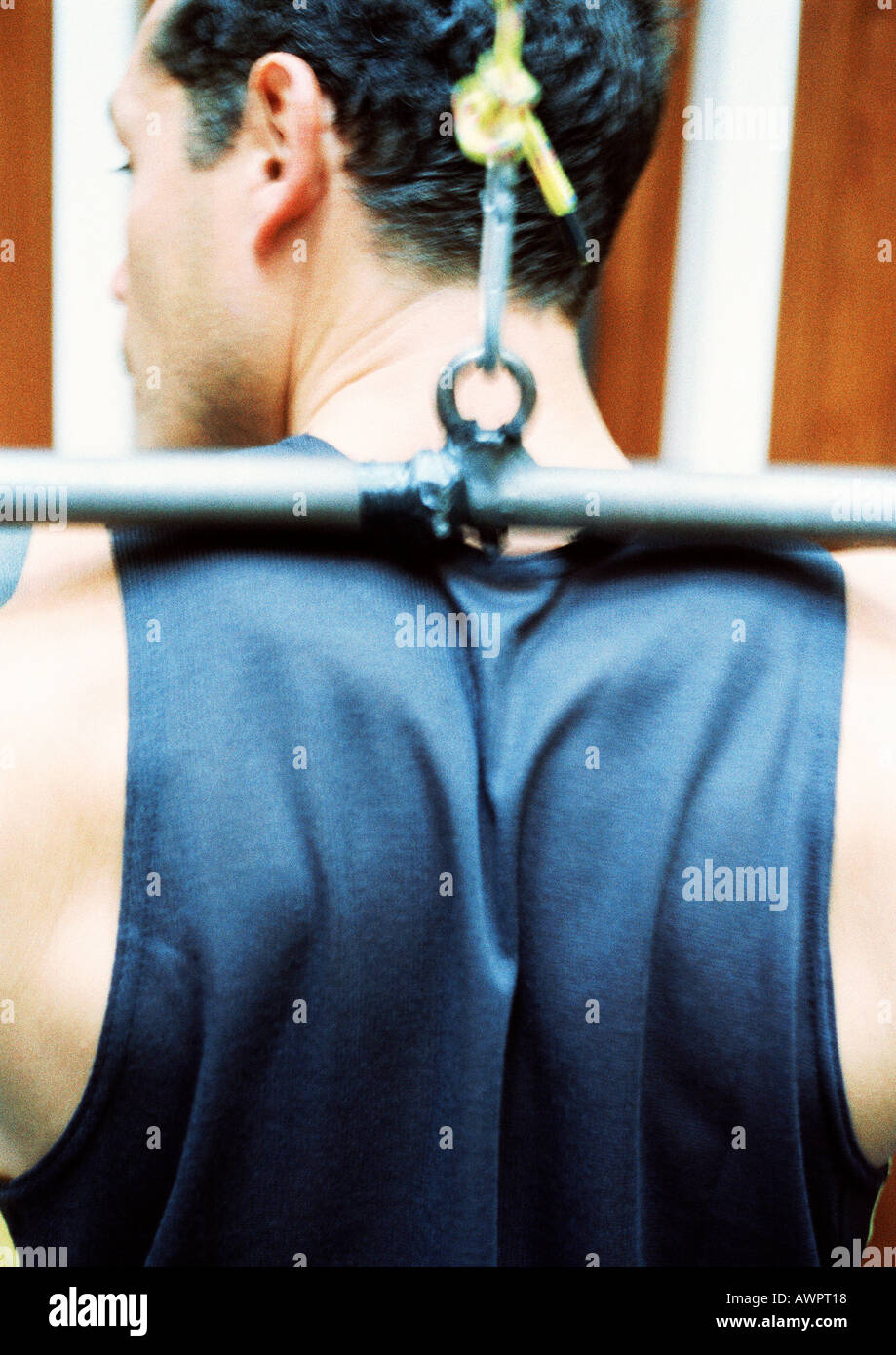 Man using weight machine, rear view, close-up Stock Photo - Alamy