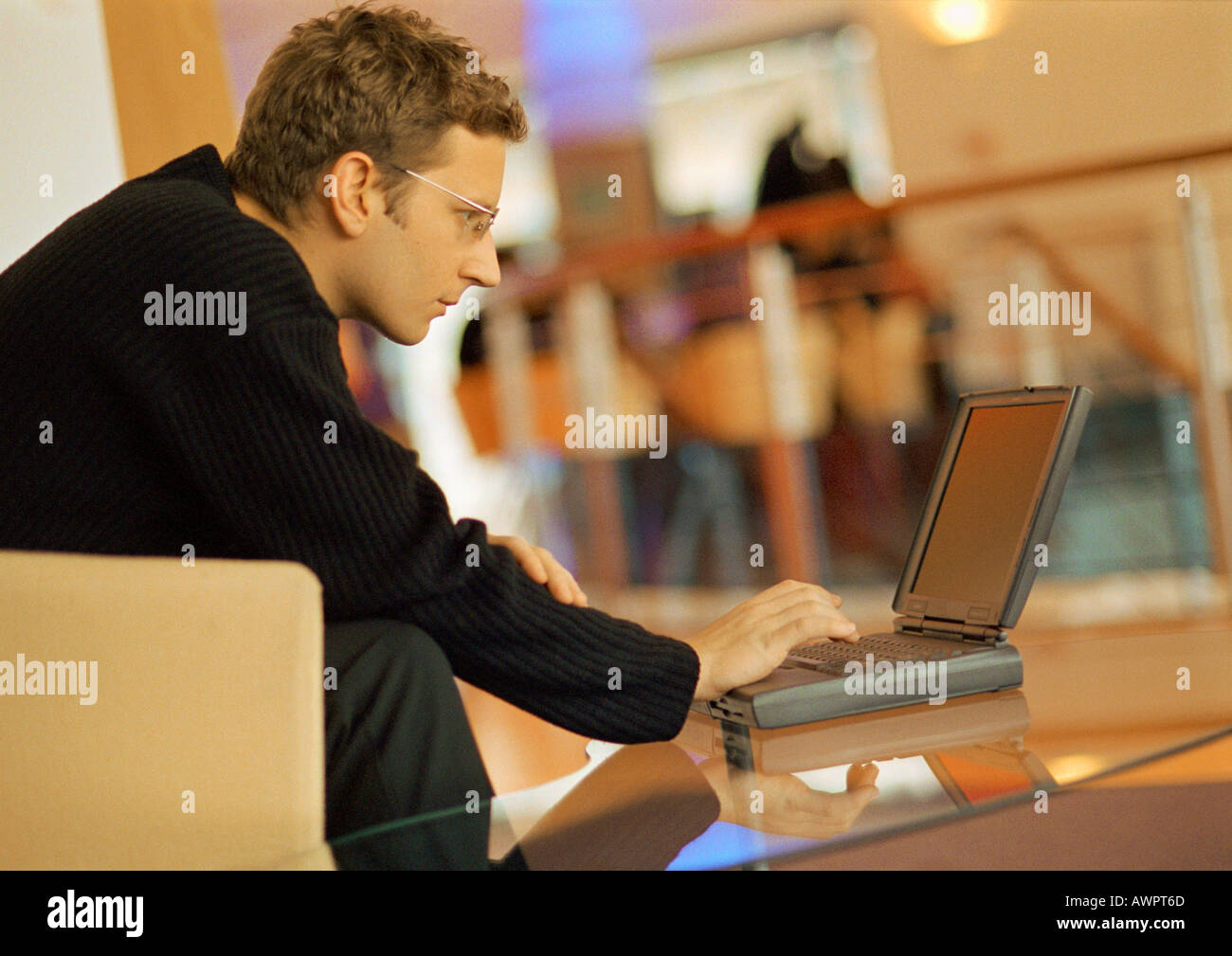 Man using laptop, side view Stock Photo - Alamy