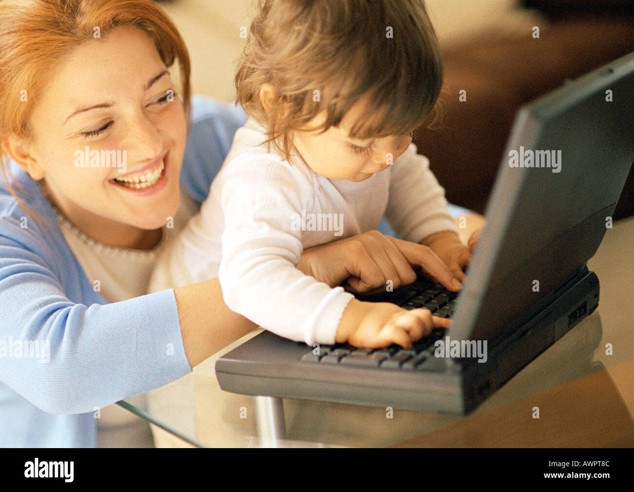 Mother and baby using laptop, portrait Stock Photo - Alamy