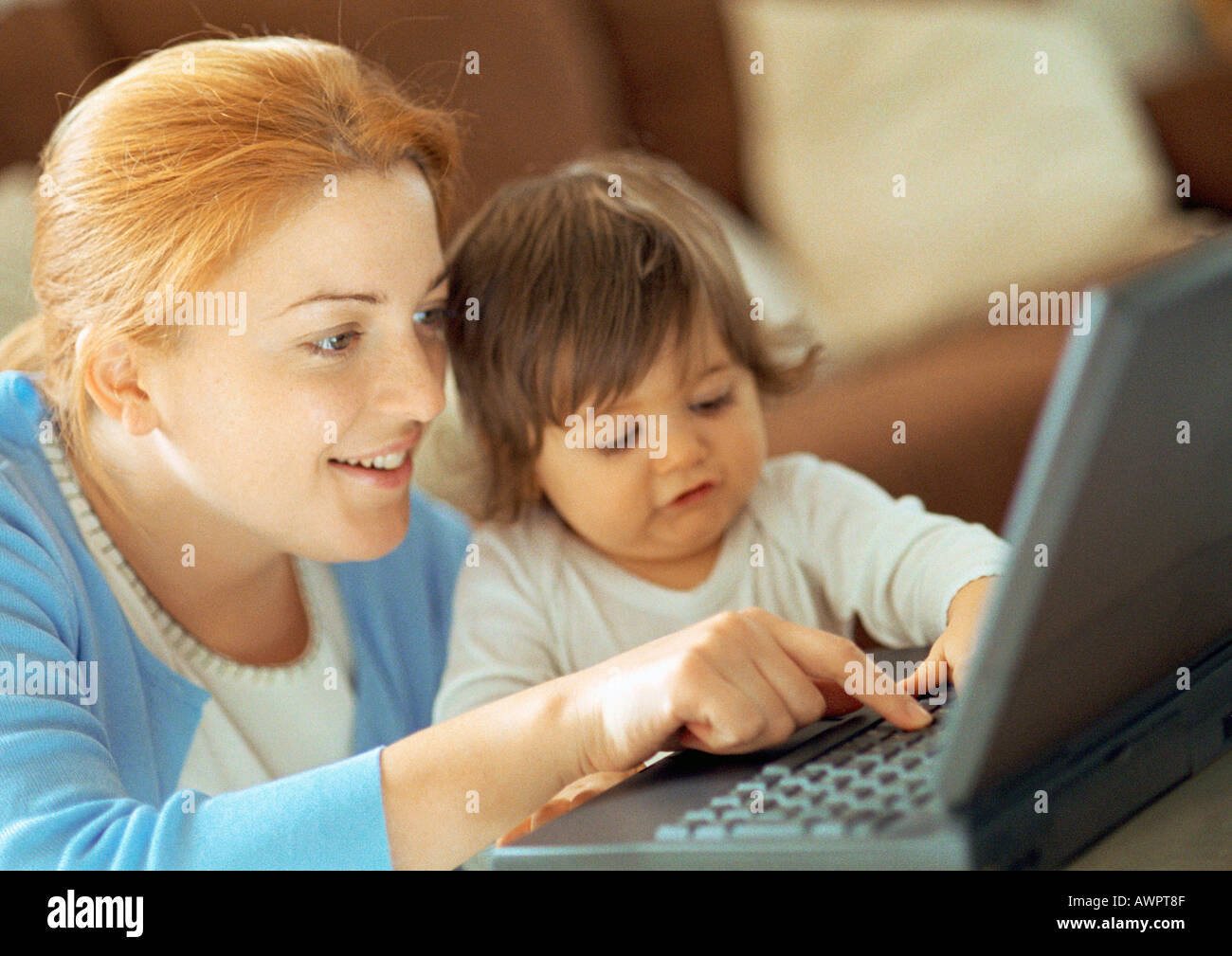 Mother and baby using laptop, portrait Stock Photo - Alamy
