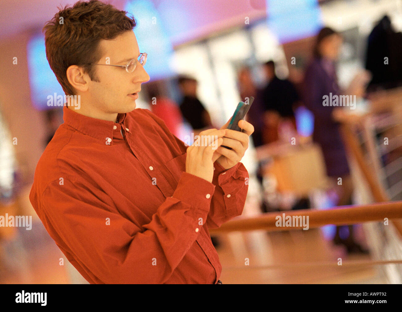 Man using cell phone, side view Stock Photo - Alamy