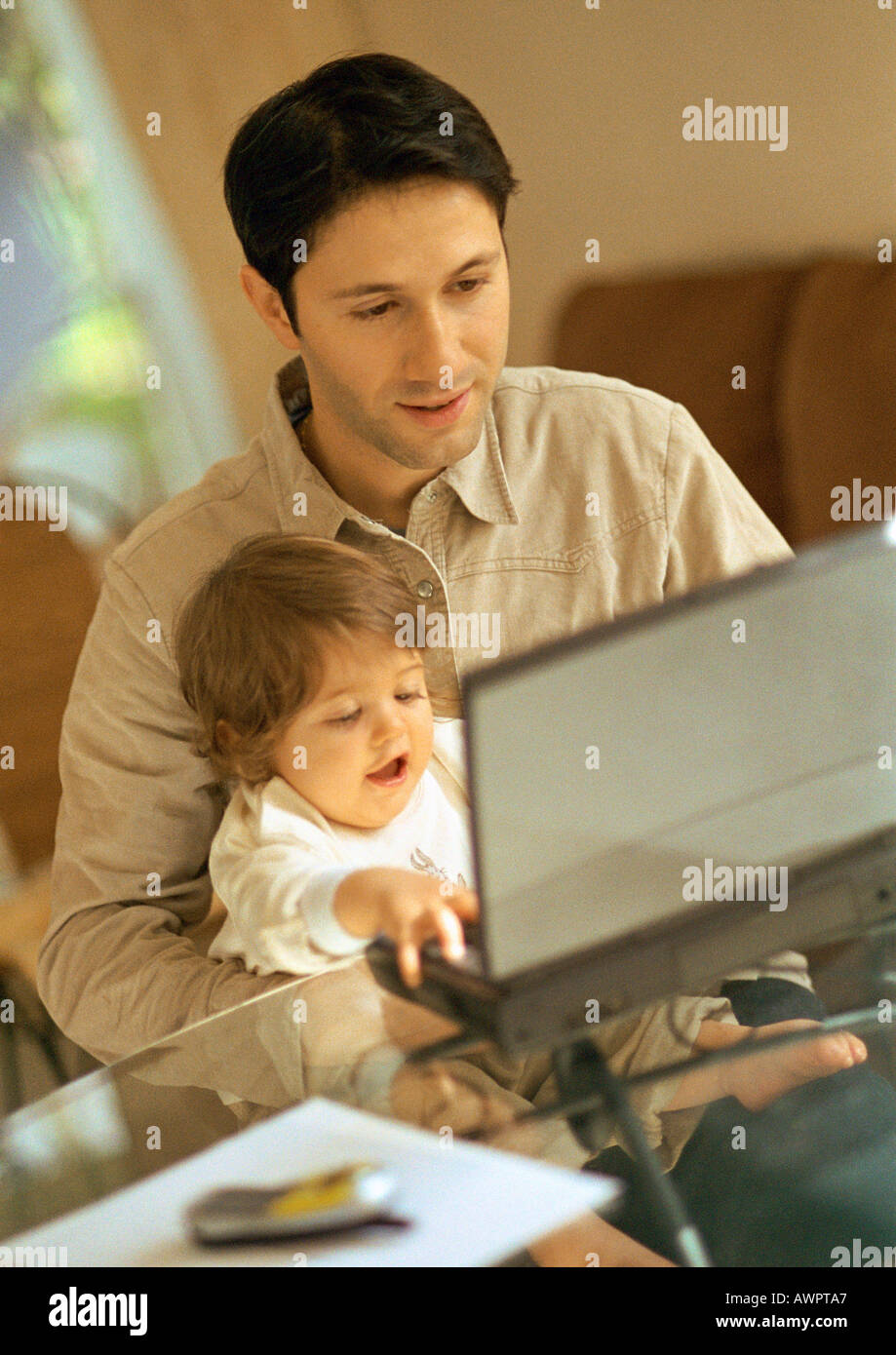 Father and baby using laptop Stock Photo - Alamy