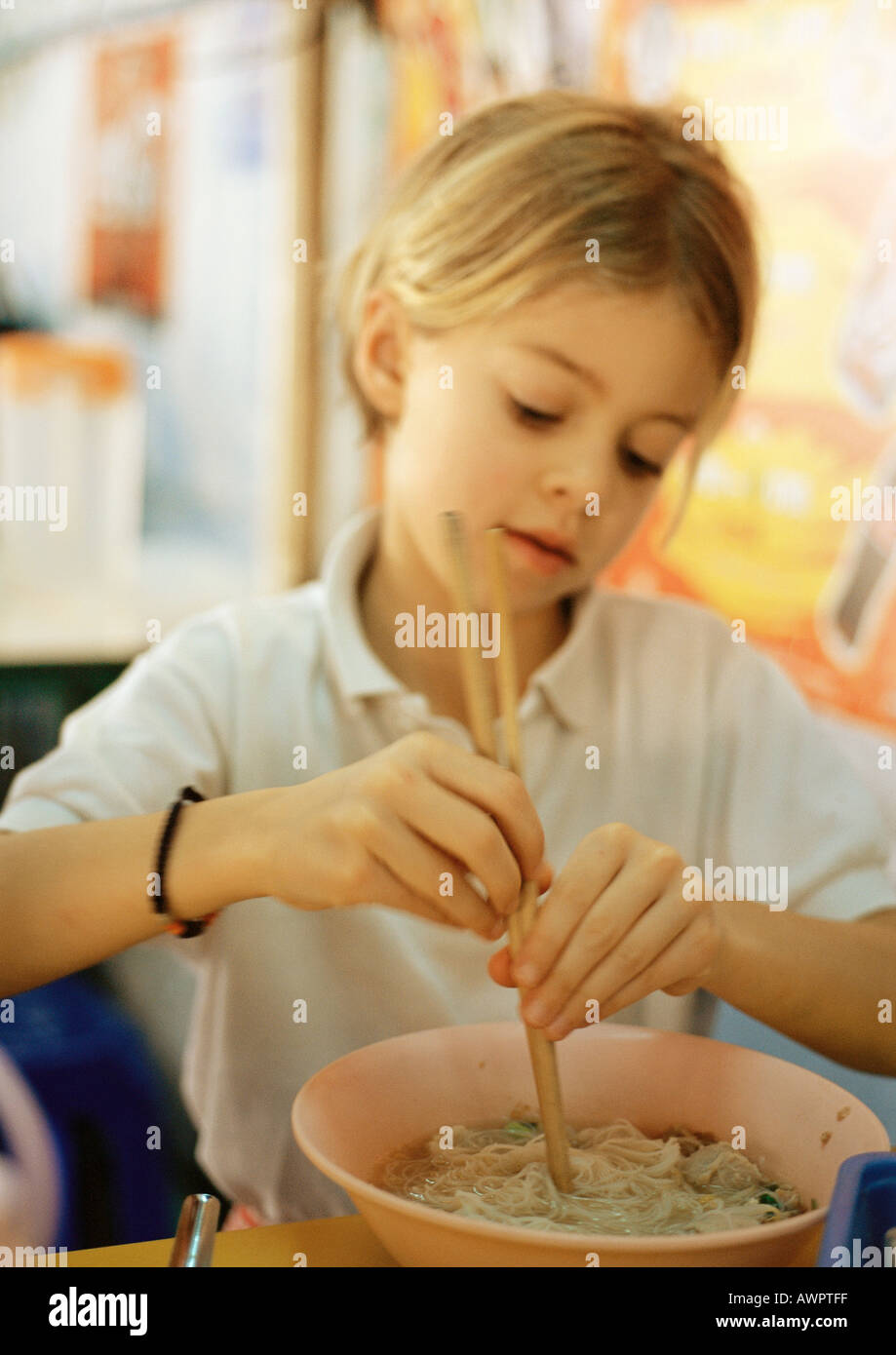 Little chinese girl eating chopsticks hi-res stock photography and ...