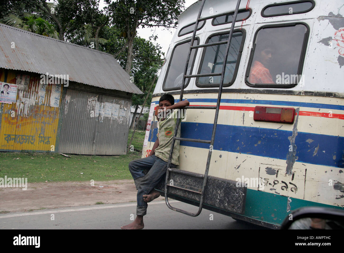 BANGLADESH Boy hanging from bus photo by Sean Sprague Stock Photo - Alamy
