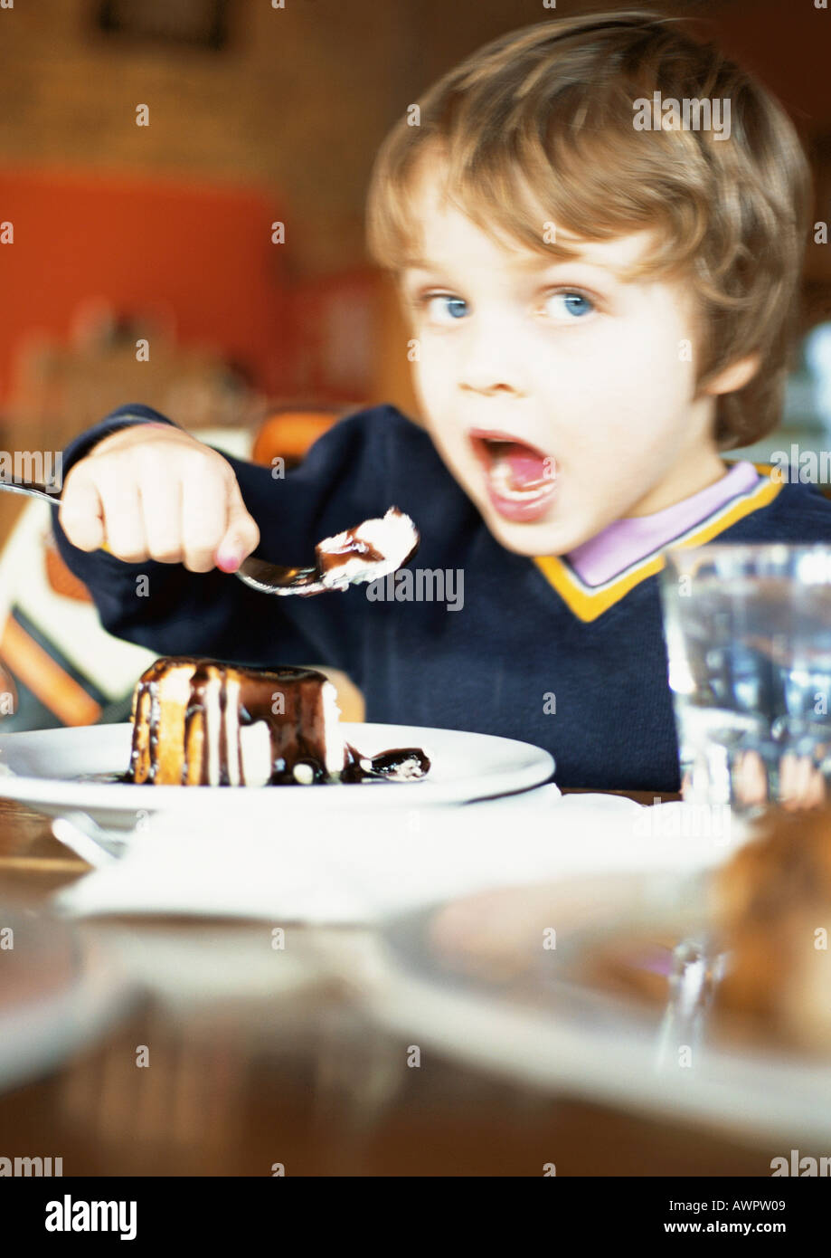 Little boy eating dessert, portrait Stock Photo - Alamy