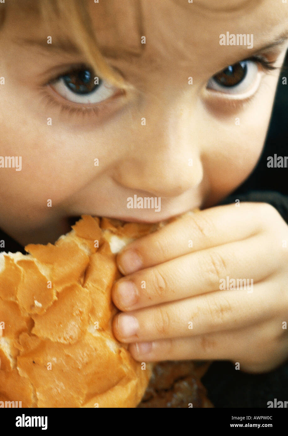Child eating bread, close-up Stock Photo - Alamy