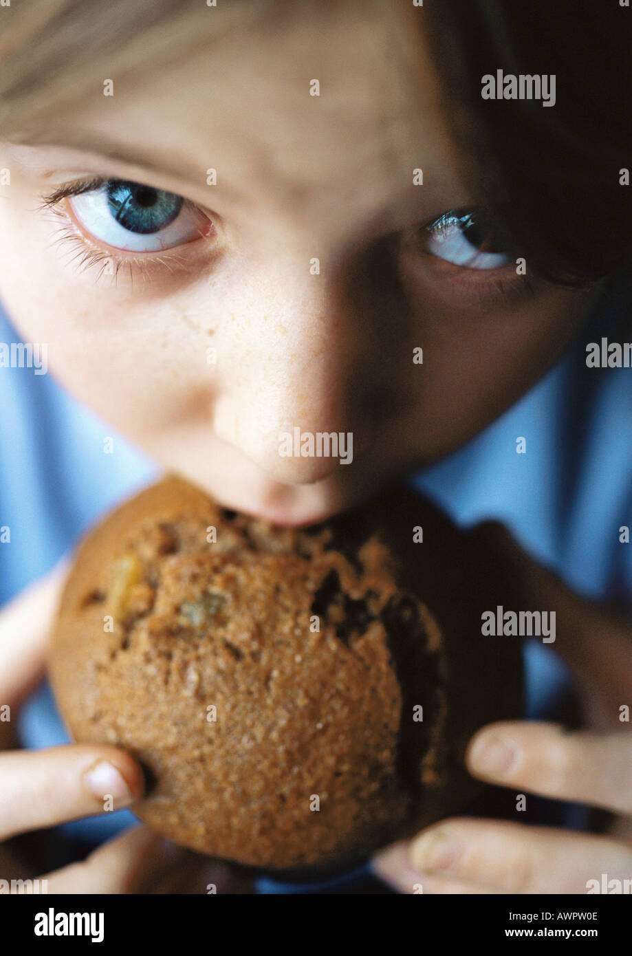Child eating muffin, close-up Stock Photo - Alamy