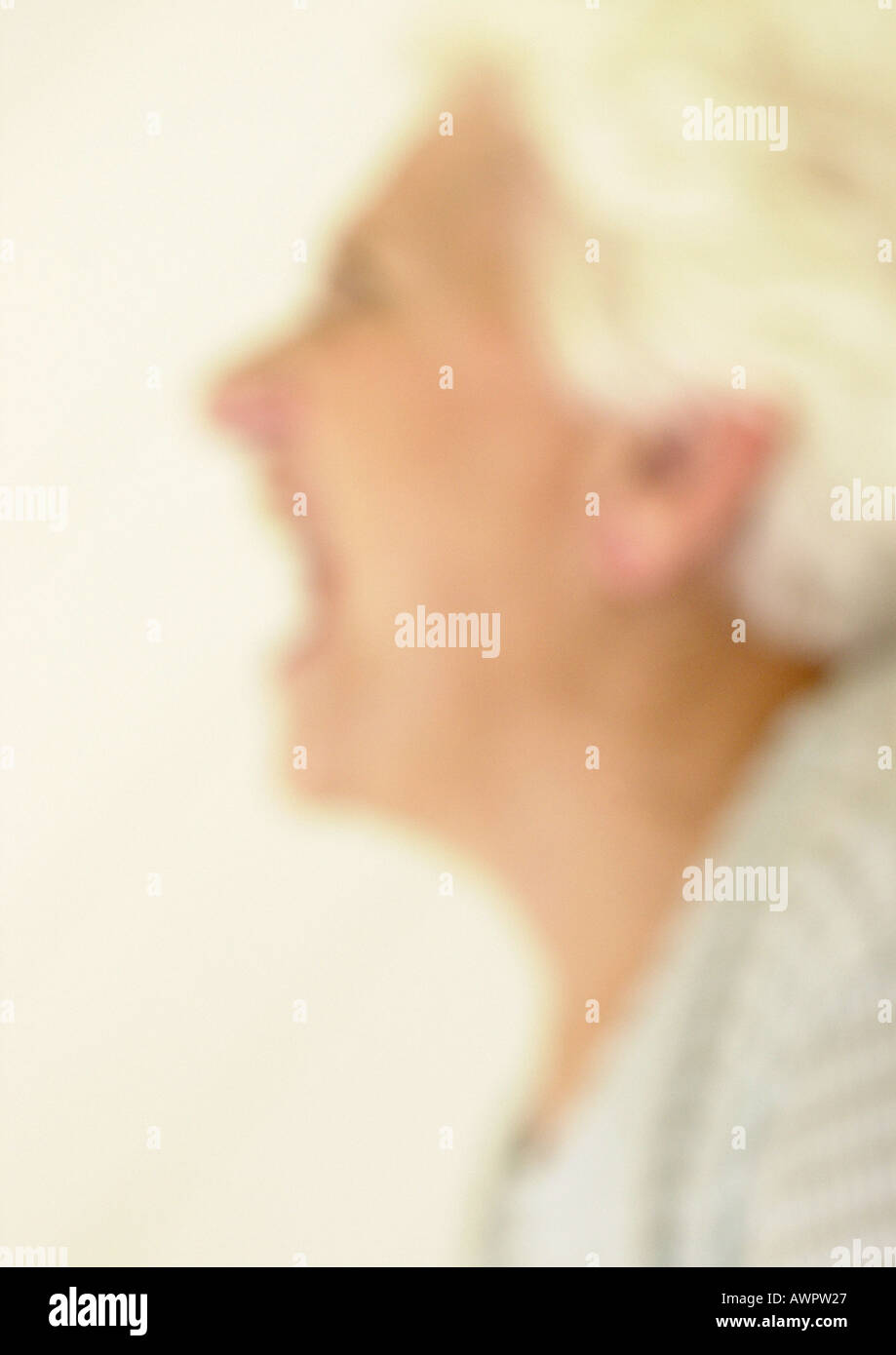 Senior woman screaming, side view, close-up, portrait, blurred Stock ...