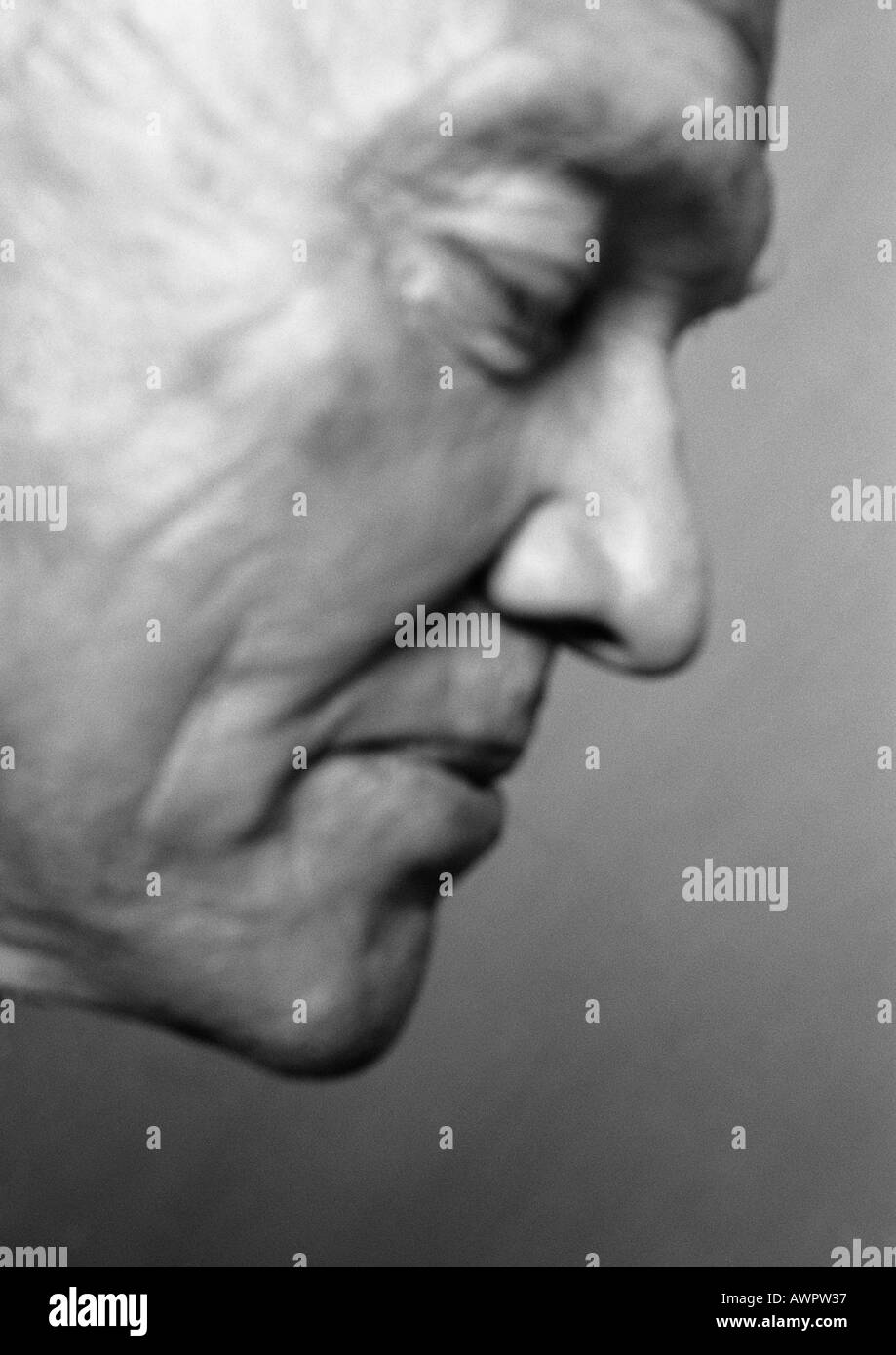 Senior man looking down, side view, close-up, b&w Stock Photo - Alamy