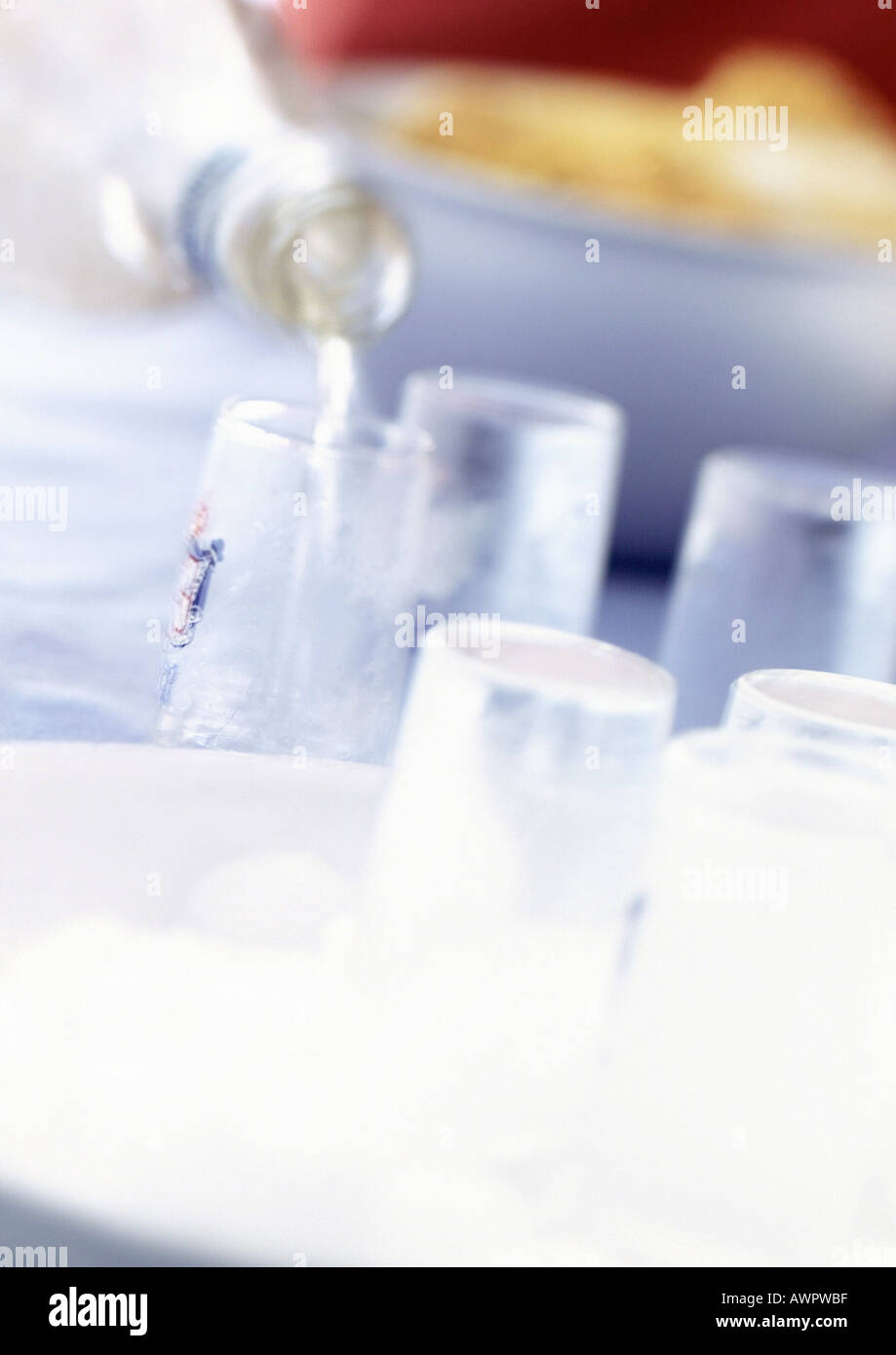 Vodka being poured into shot glasses Stock Photo - Alamy